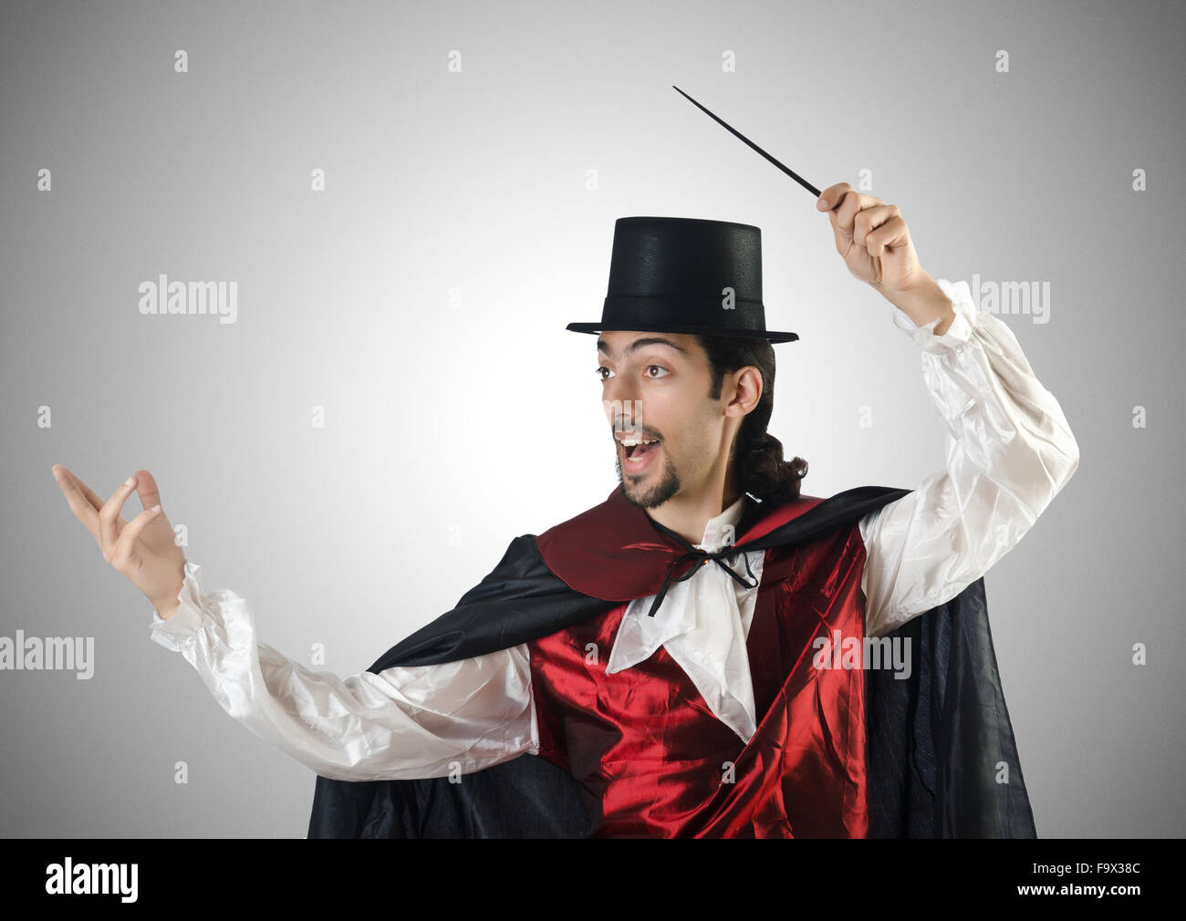 Magician doing tricks on white Stock Photo - Alamy