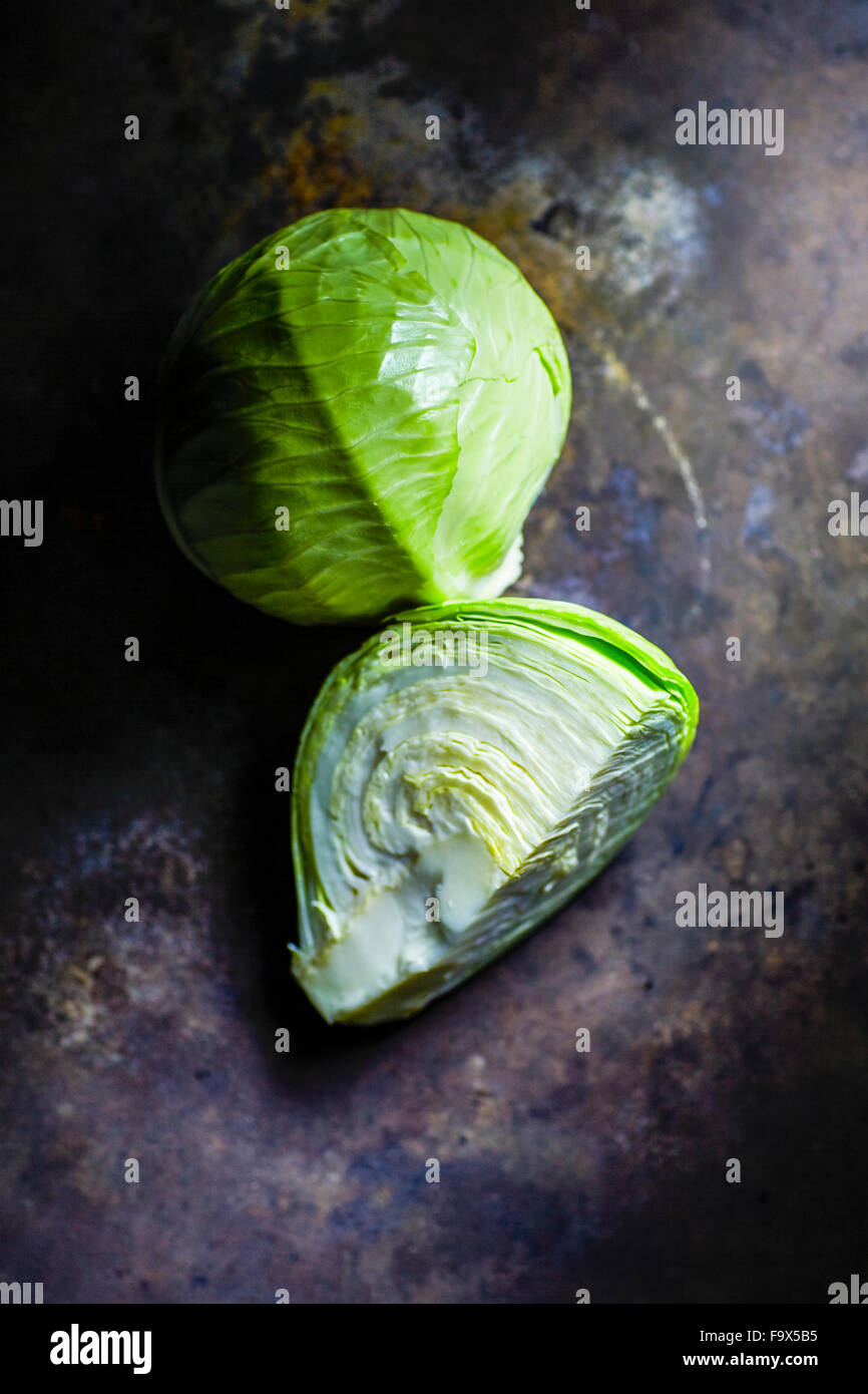 Whole and quarter of white cabbage on dark ground Stock Photo - Alamy