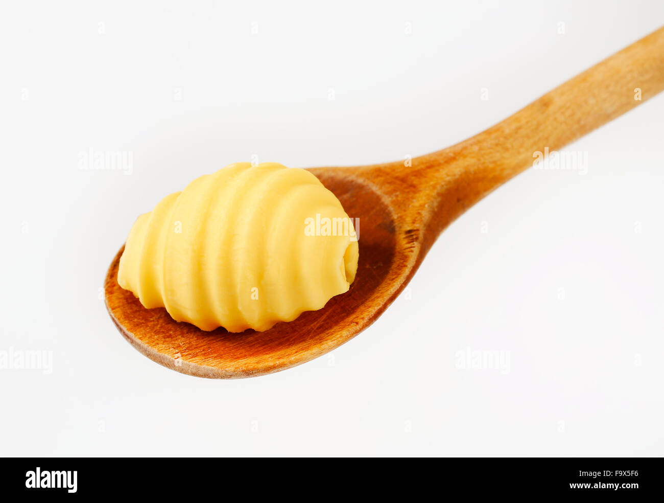 Butter curl on wooden spoon Stock Photo - Alamy