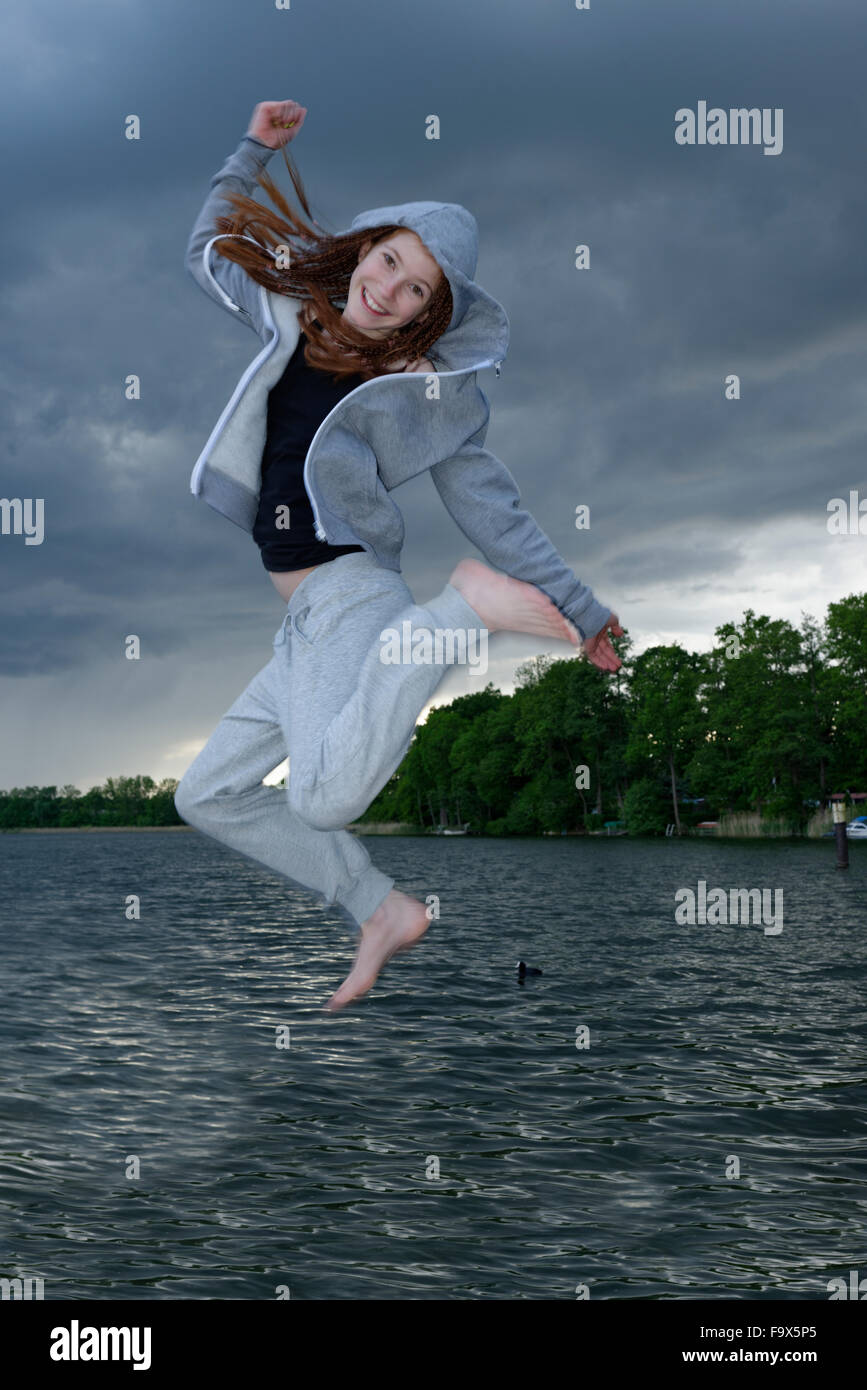 Girl 12 13 jumping into lake hi-res stock photography and images - Alamy