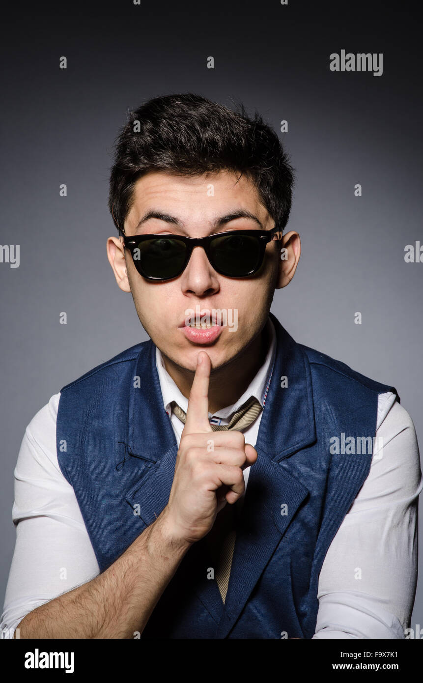 Young man in blue vest against gray Stock Photo - Alamy
