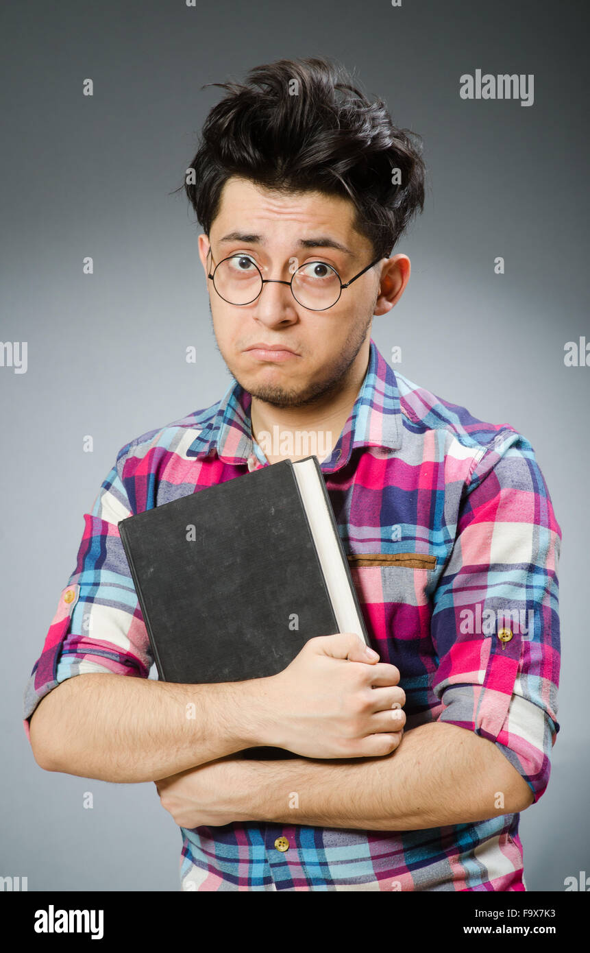 Funny student with many books Stock Photo - Alamy