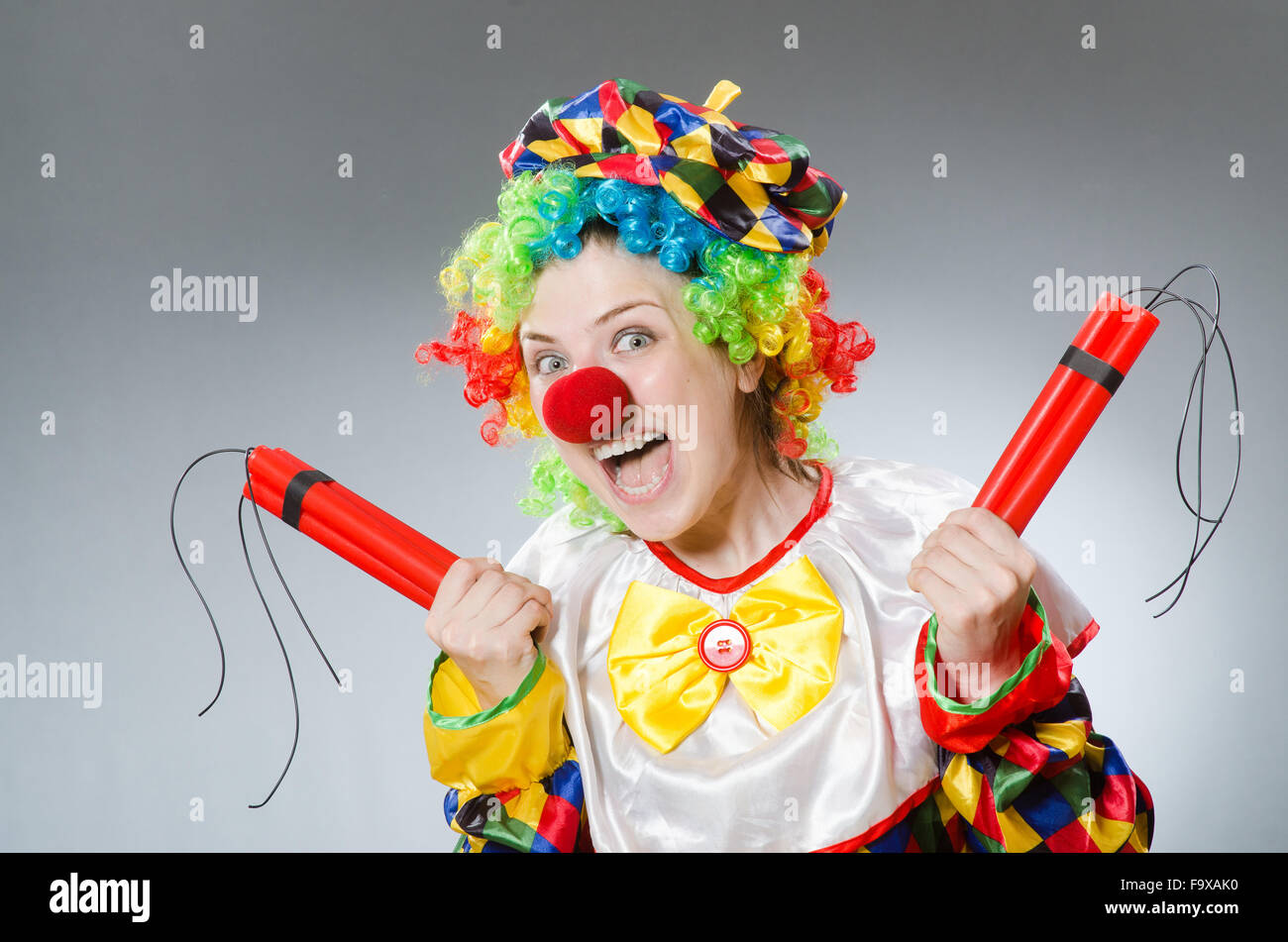 Clown with dynamite in funny concept Stock Photo - Alamy