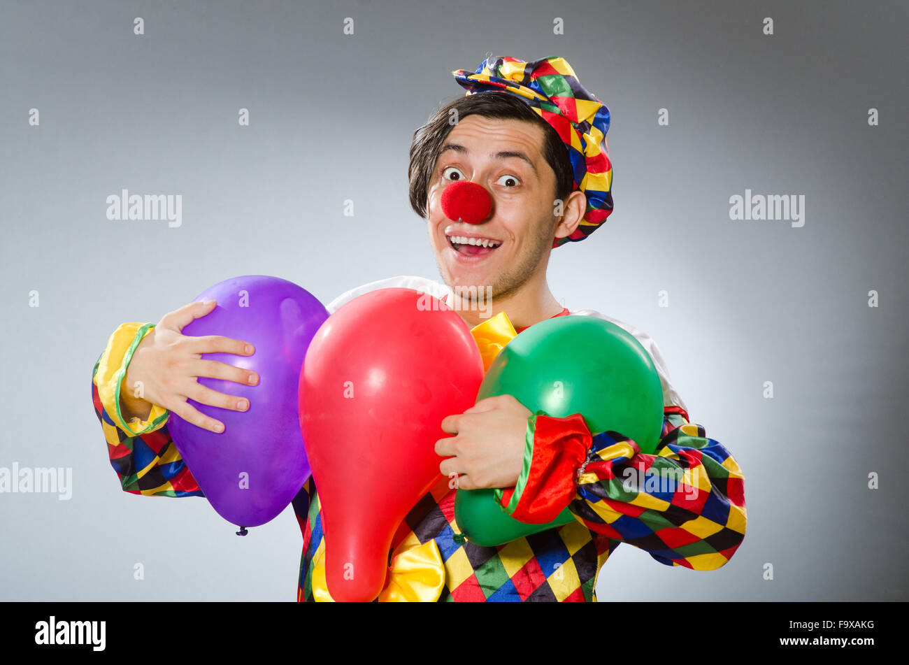 Clown with balloons in funny concept Stock Photo - Alamy