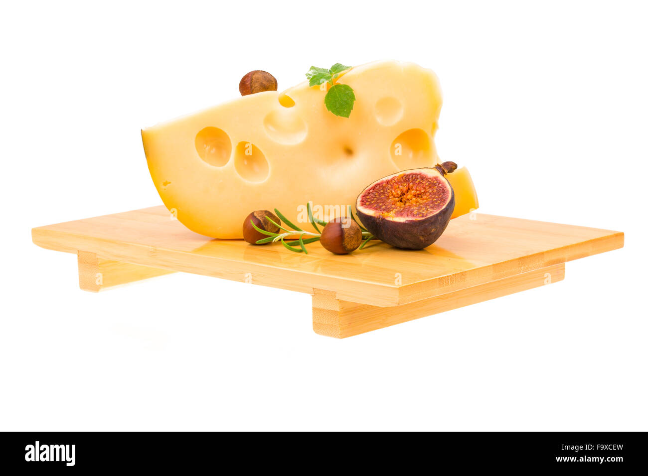 Maasdam cheese with fig and herbs Stock Photo - Alamy