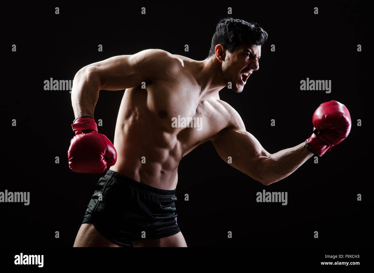 Muscular man in boxing concept Stock Photo - Alamy
