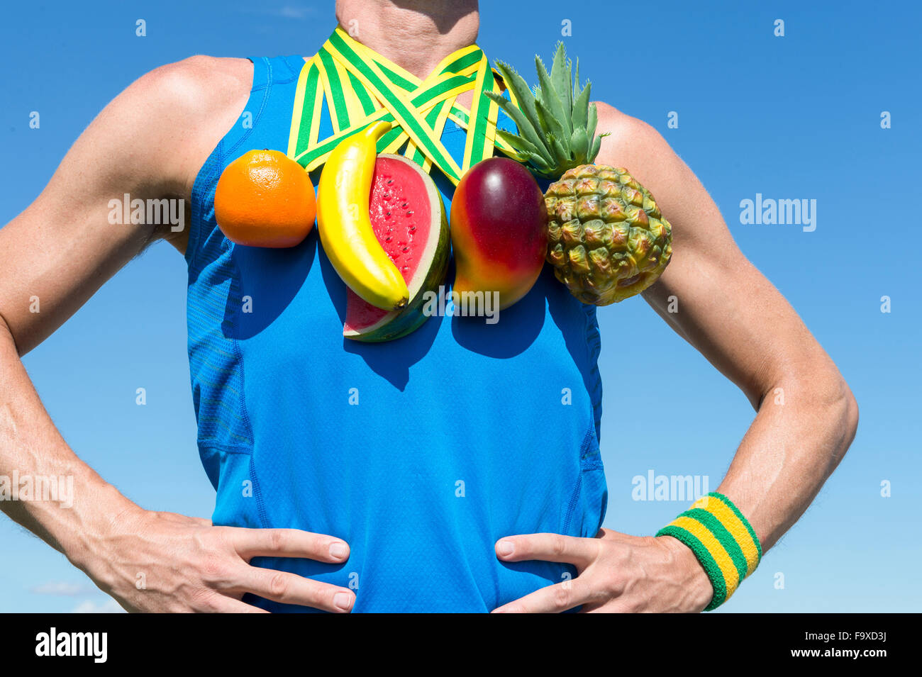 Winner of healthy eating competition standing with fruit medals ...