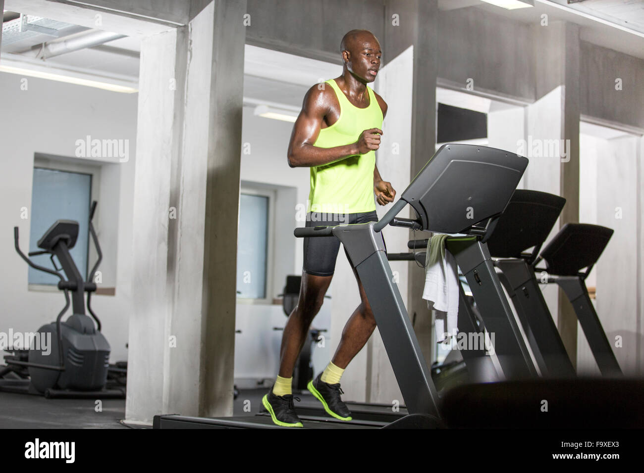 Athlete running on treadmill in gym Stock Photo - Alamy