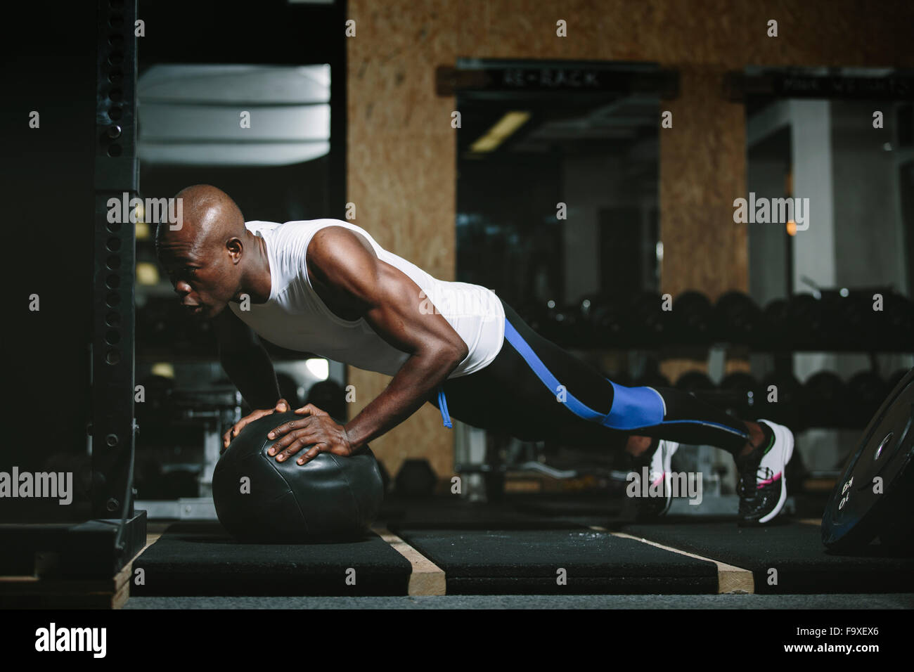 Physical athlete doing push-ups on medicine ball in gym Stock Photo - Alamy