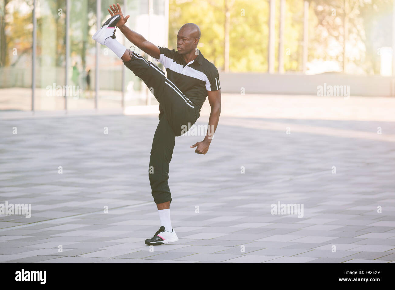 Athlete doing stretching exercises Stock Photo - Alamy