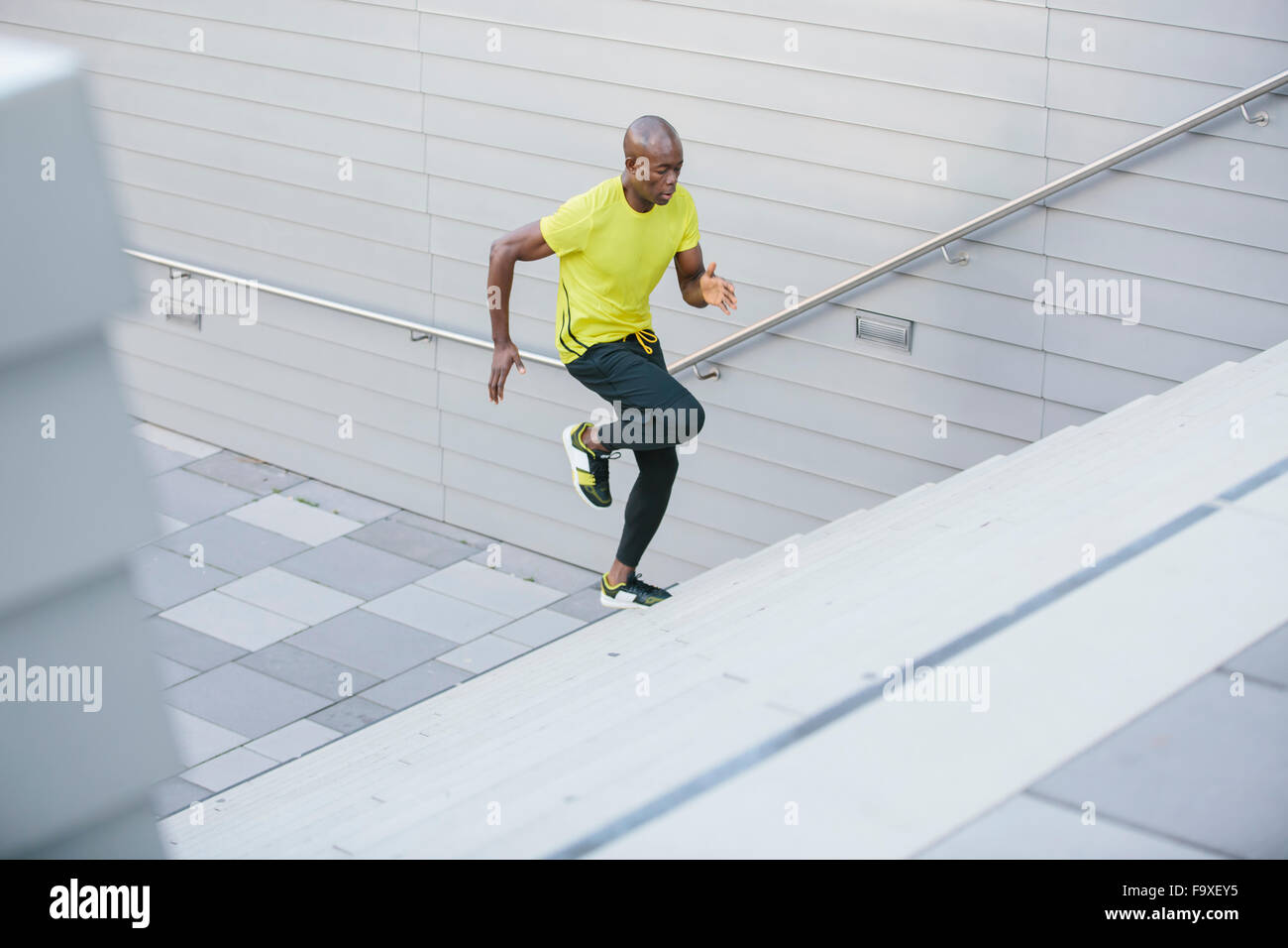 Athlete running up stairs Stock Photo - Alamy