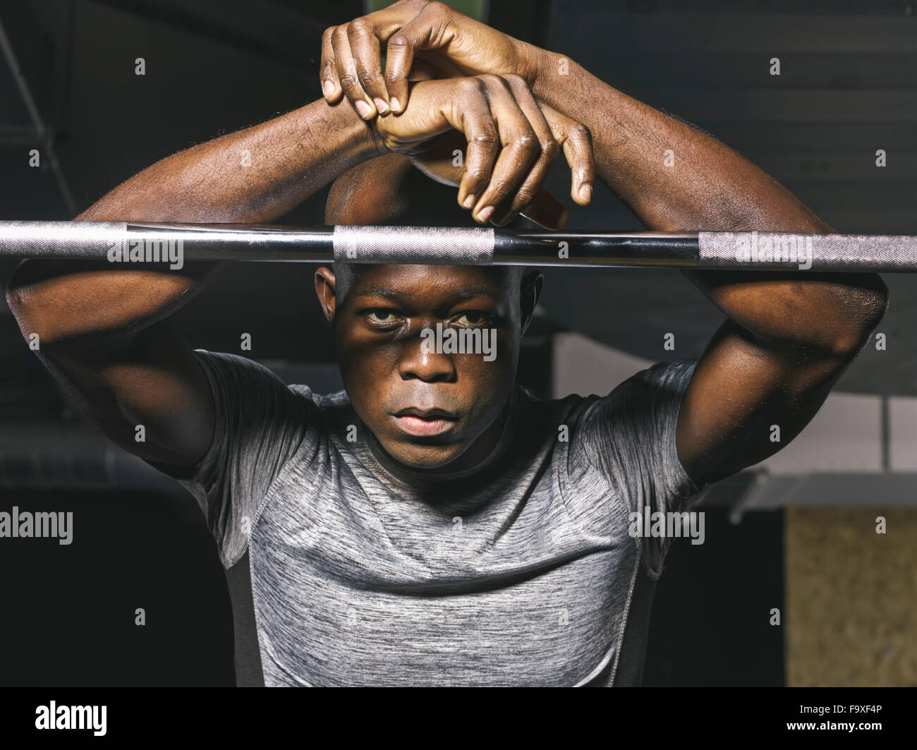 Portrait of physical athlete resting on barbell in gym Stock Photo - Alamy