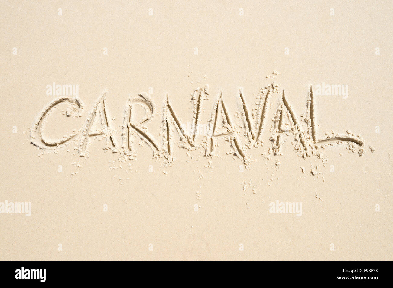 Carnaval message handwritten in smooth sand on Ipanema Beach in Rio de ...
