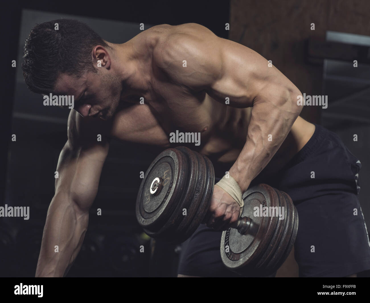 Athlete with dumbbells, training of back muscles Stock Photo - Alamy