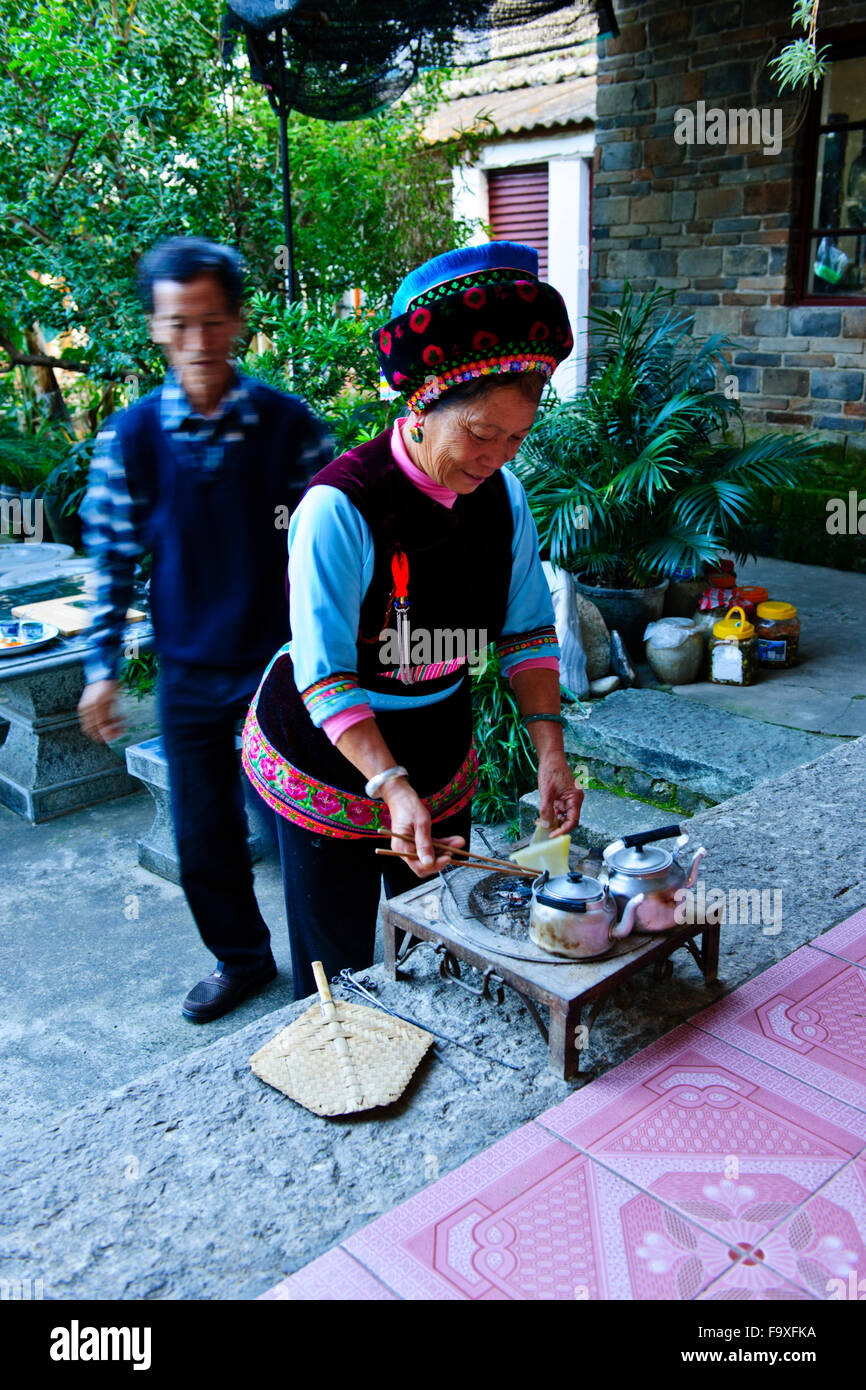 Bai women cooking in typical village house preparing special tea hi-res ...