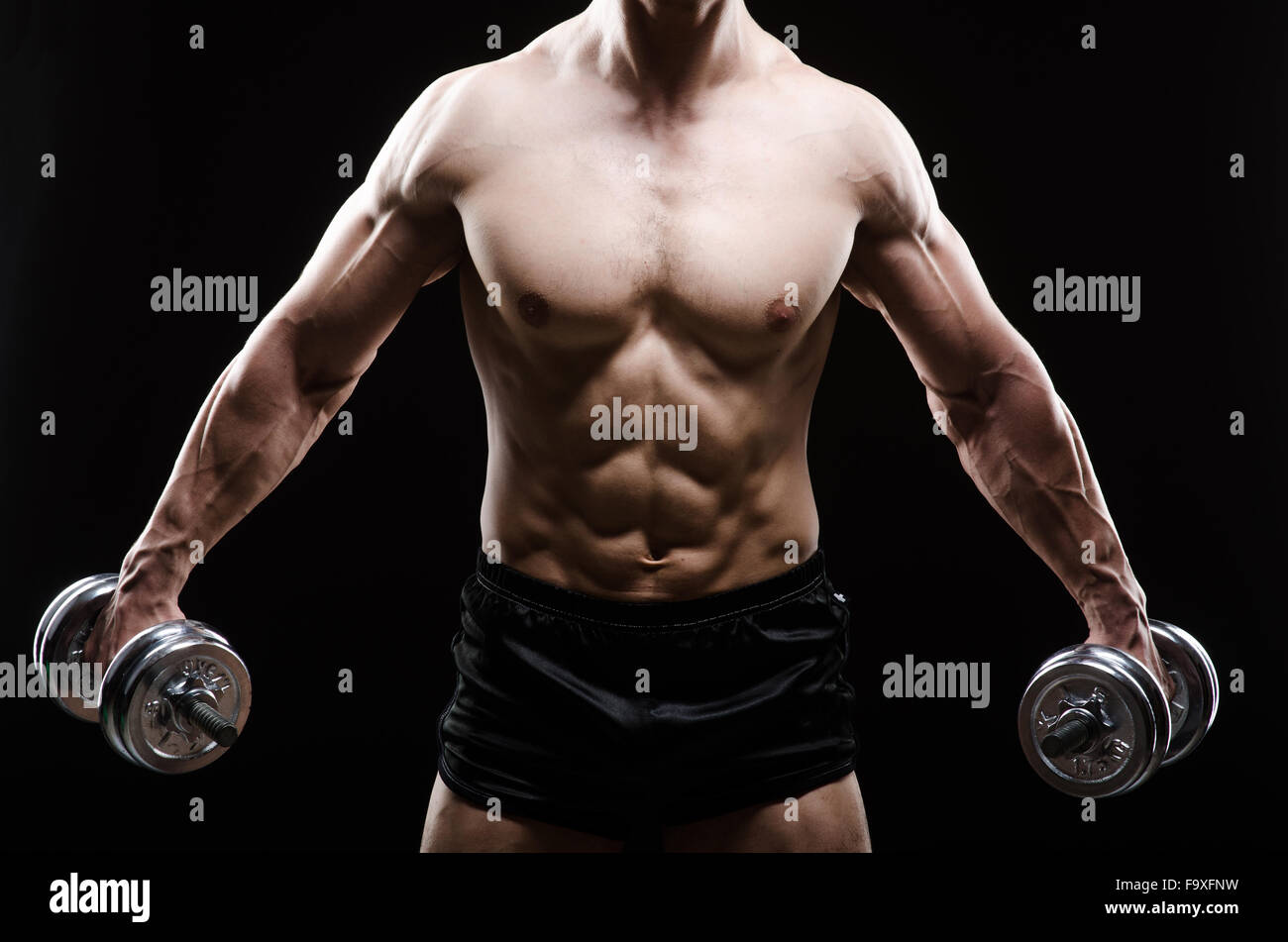 Muscular ripped bodybuilder with dumbbells Stock Photo - Alamy