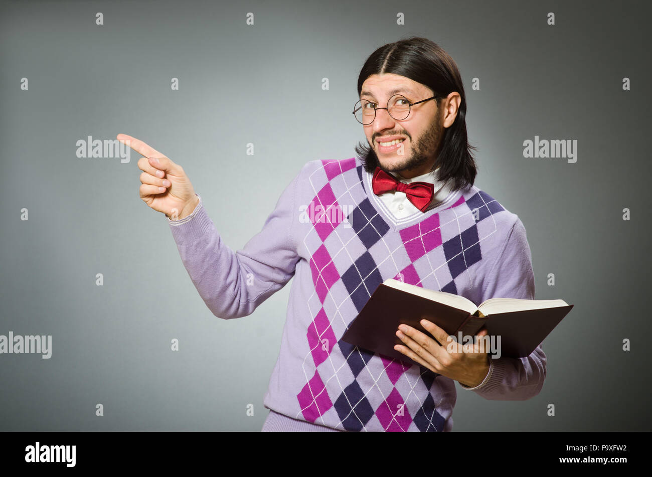 Young student with book in learning concept Stock Photo - Alamy