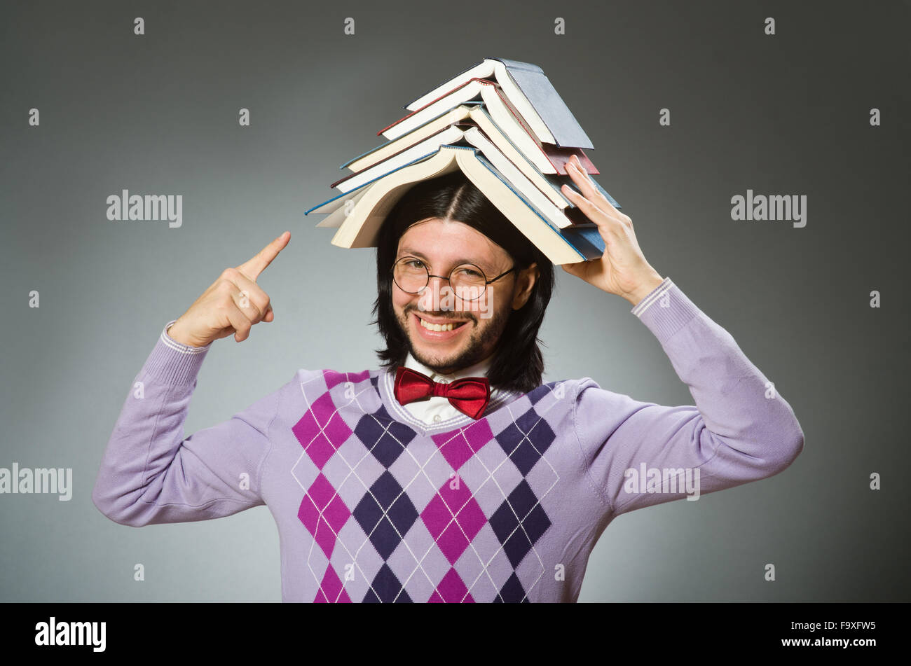 Young student with book in learning concept Stock Photo - Alamy