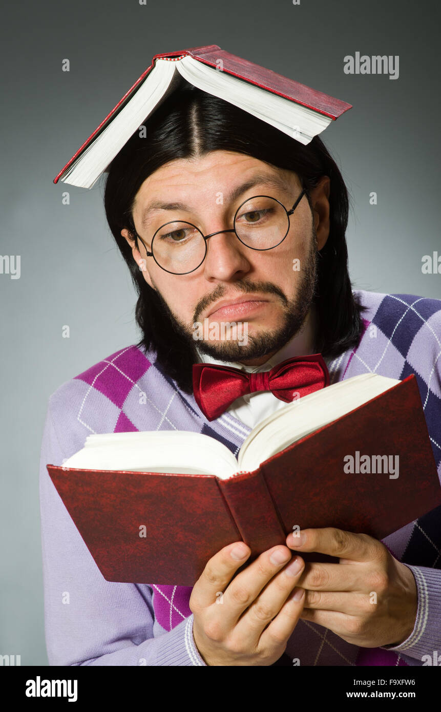 Young student with book in learning concept Stock Photo - Alamy