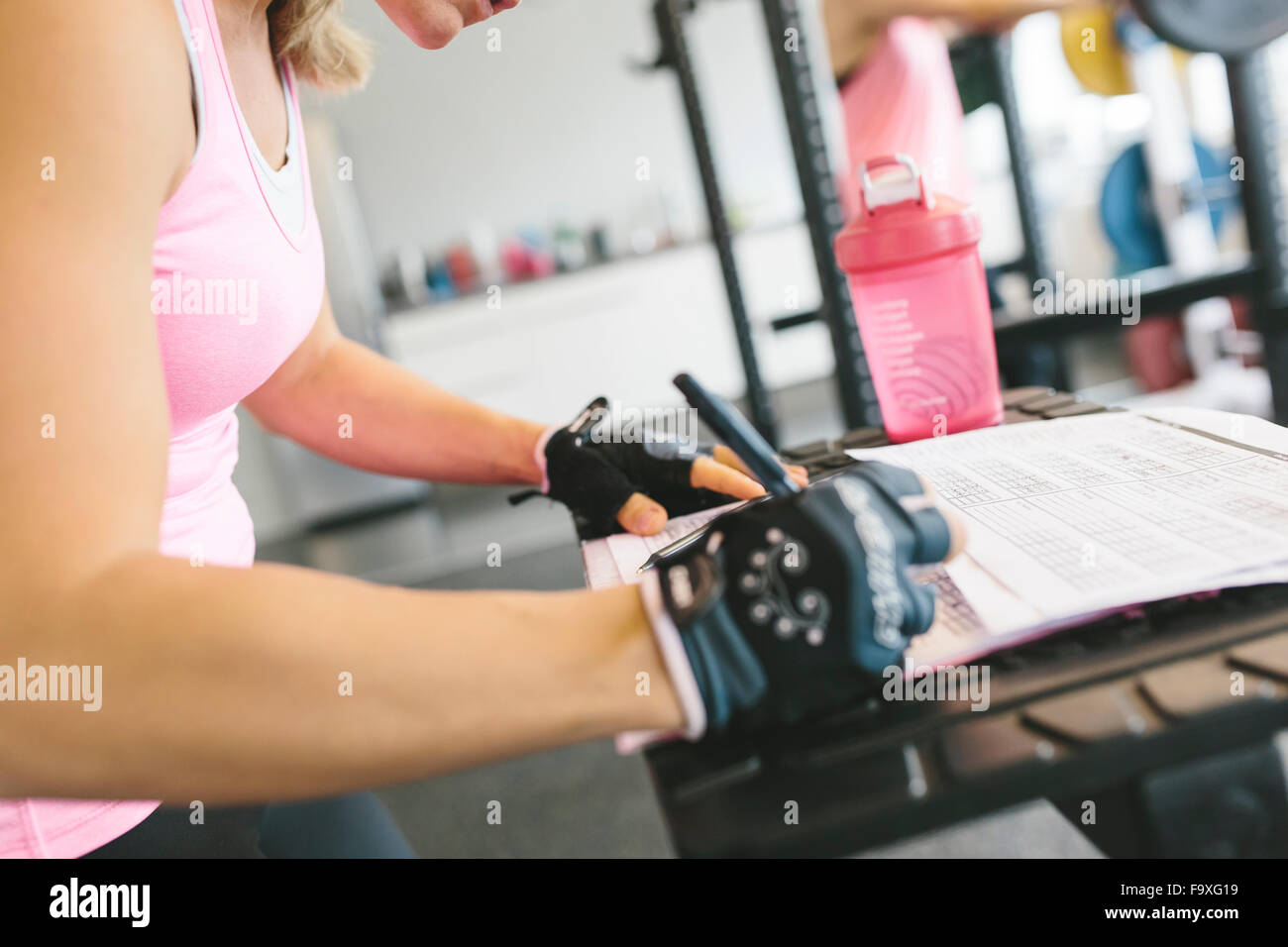 Woman planning her workout routine in gym Stock Photo - Alamy