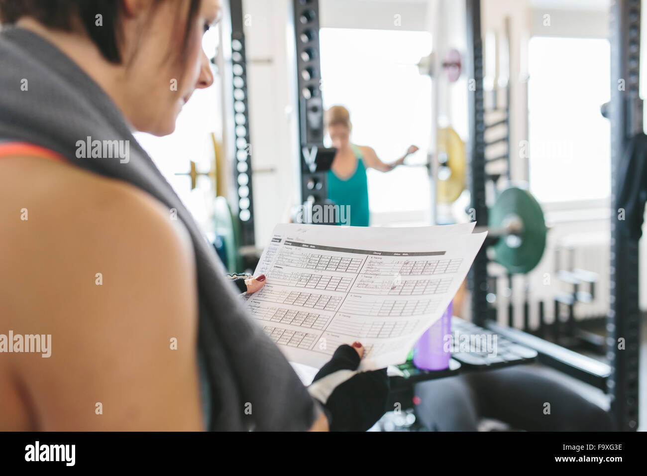 Woman checking her workout routine in gym Stock Photo - Alamy