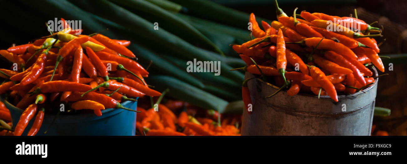 Red Chillies in bucket and laying around at local market of Indonesia ...