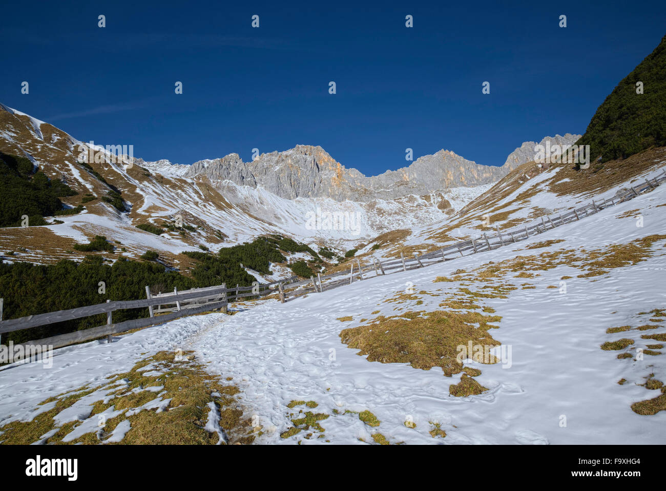 wooden fence and view of Scharnitzspitze and Oberreintalspitze in the ...