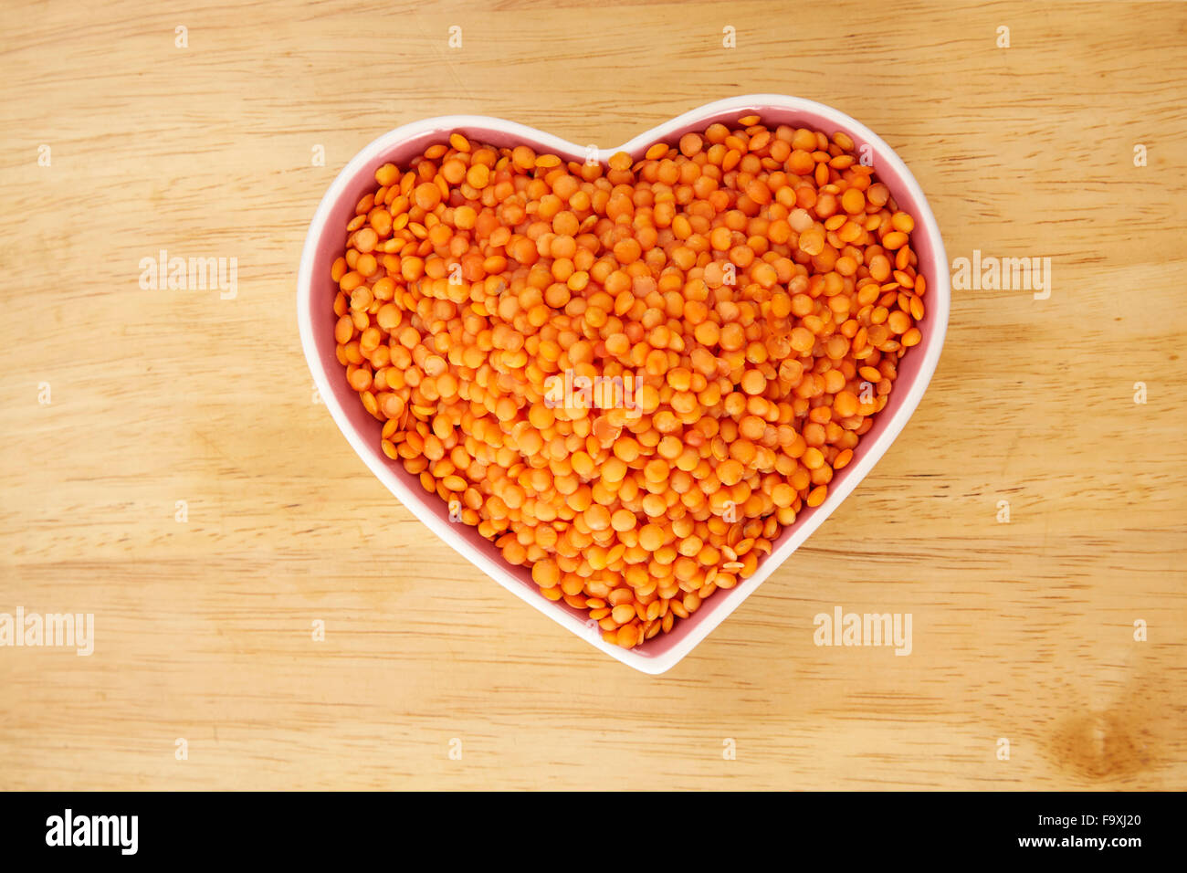 red rentils in the heart shape container Stock Photo - Alamy