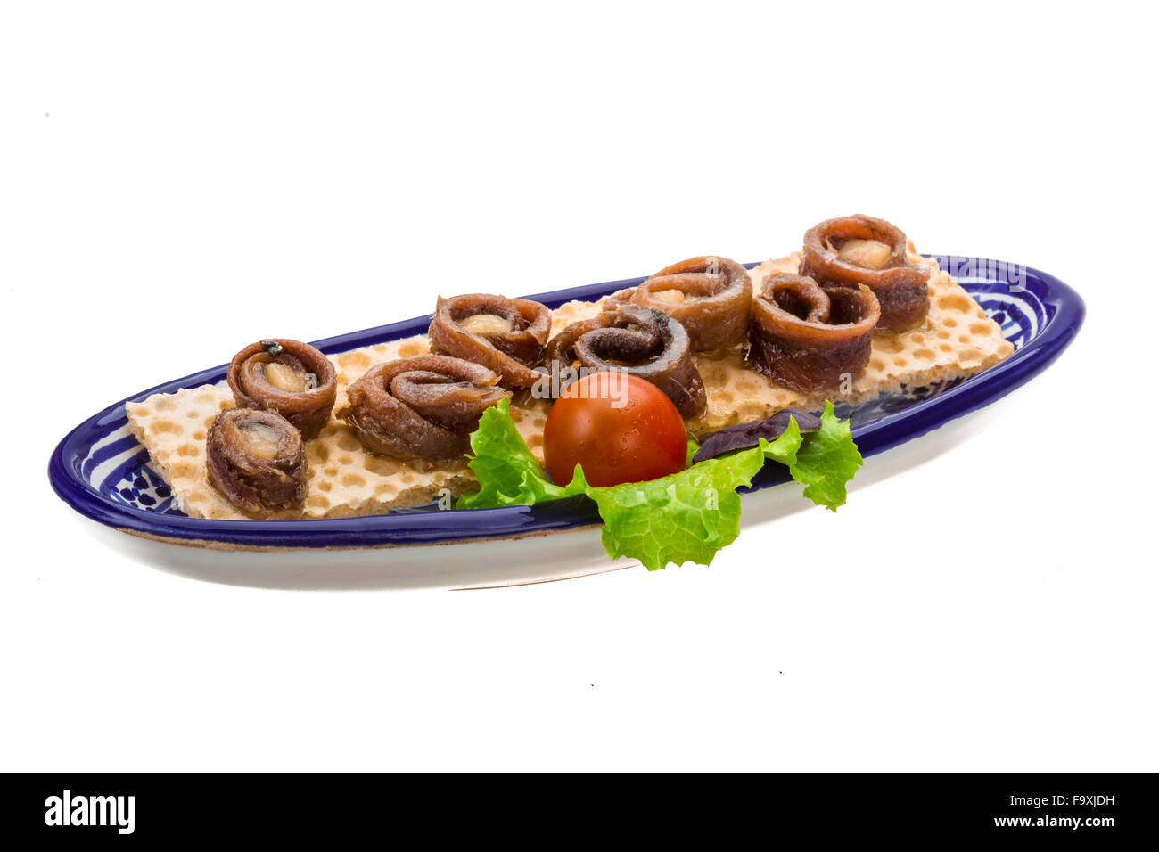 Anchovy snack with salad and tomato Stock Photo - Alamy