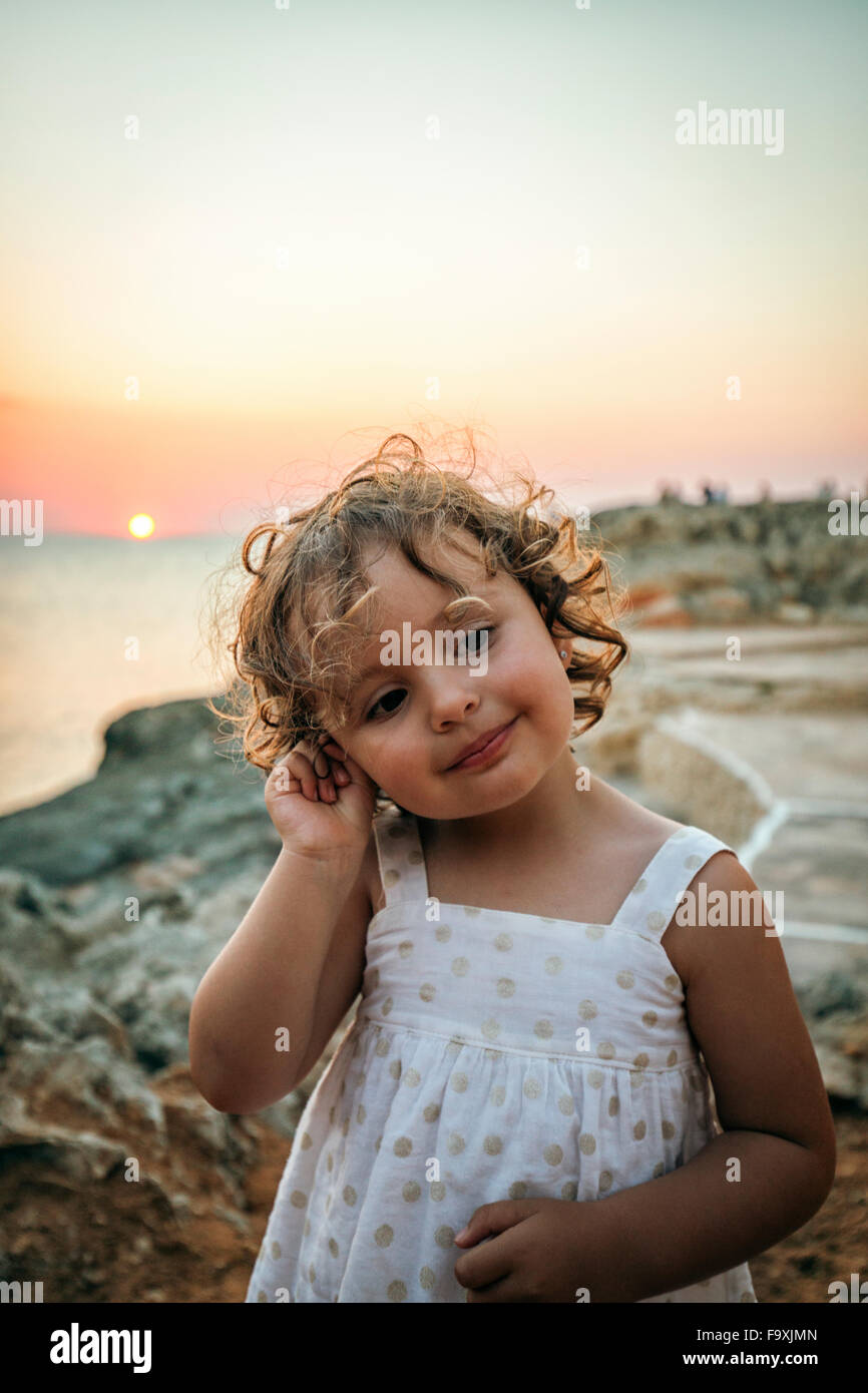 Spain, Menorca, portrait of smiling little girl at sunset Stock Photo ...