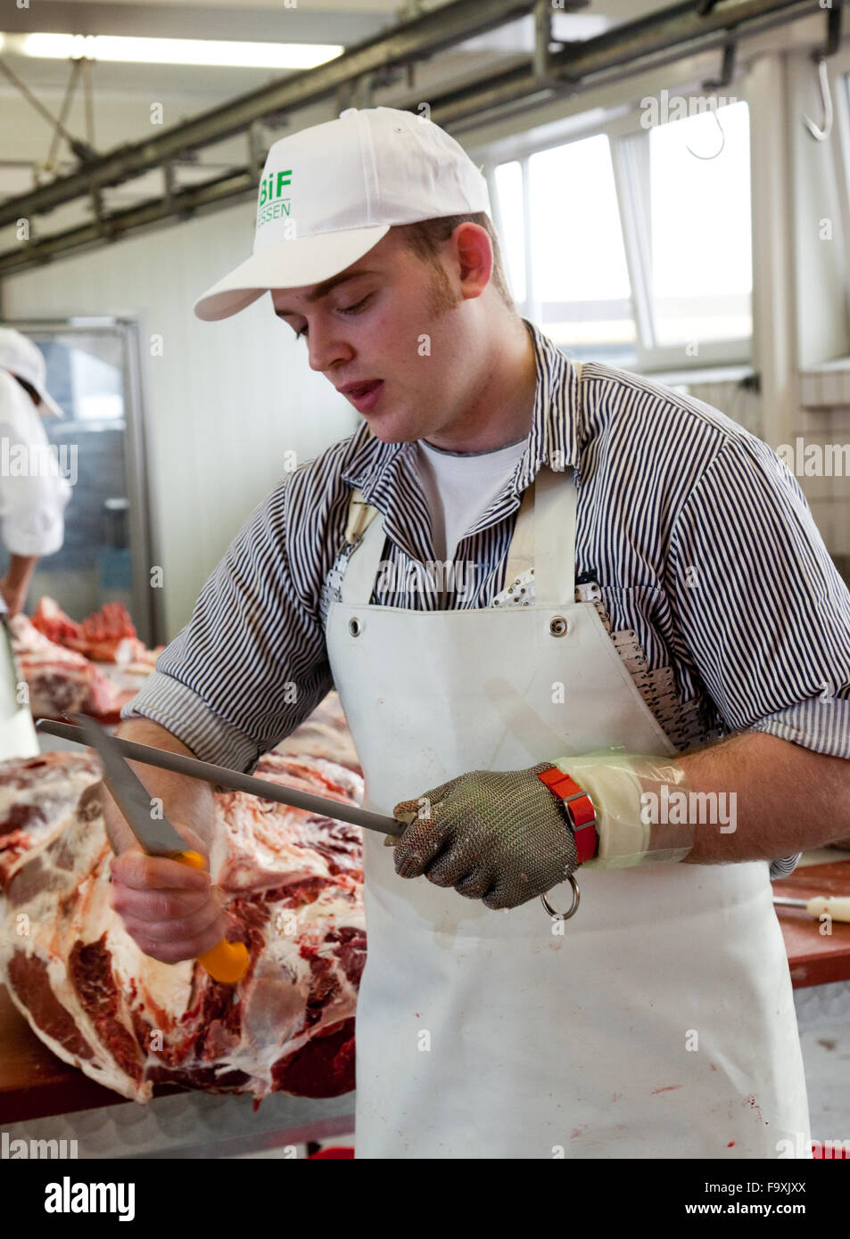 Butcher sharpening his knife Stock Photo - Alamy