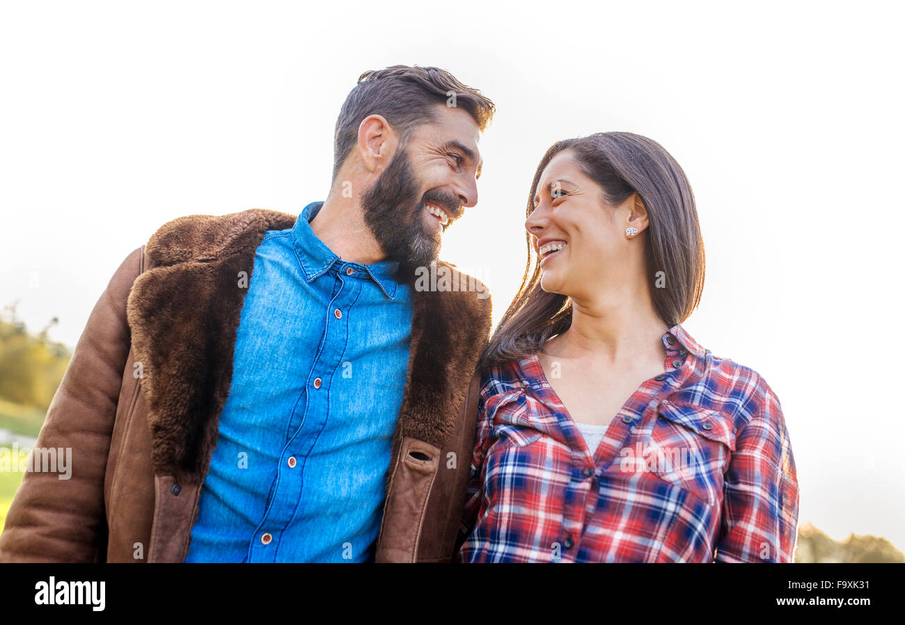 Happy couple laughing at each other Stock Photo - Alamy