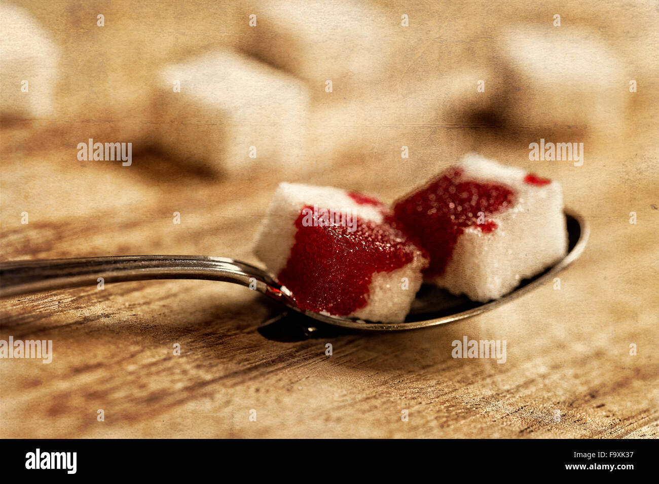 Sugar cubes with blood on spoon Stock Photo - Alamy