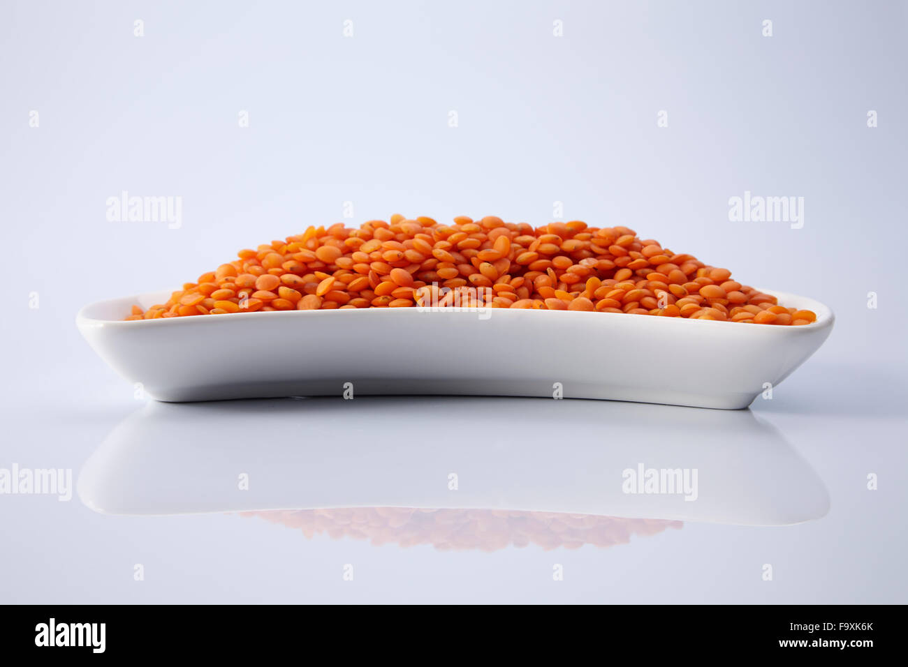 red rentils on the white background Stock Photo - Alamy