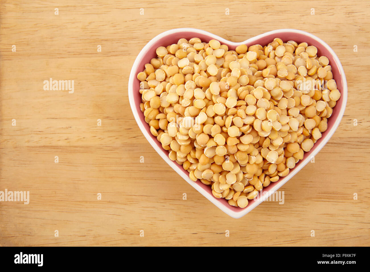 yellow daal in the heart shape container Stock Photo - Alamy