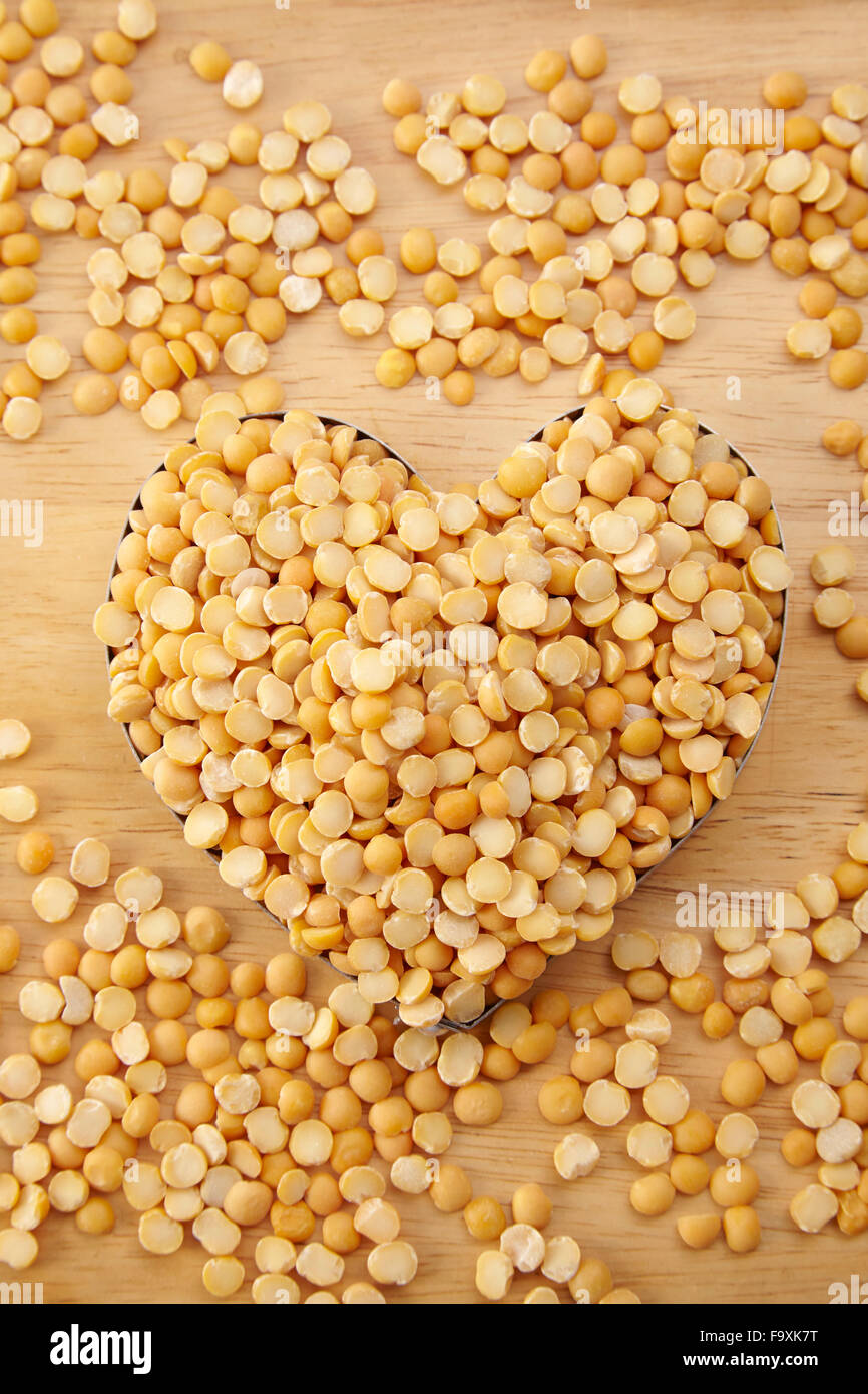 yellow daal in the heart shape container Stock Photo - Alamy