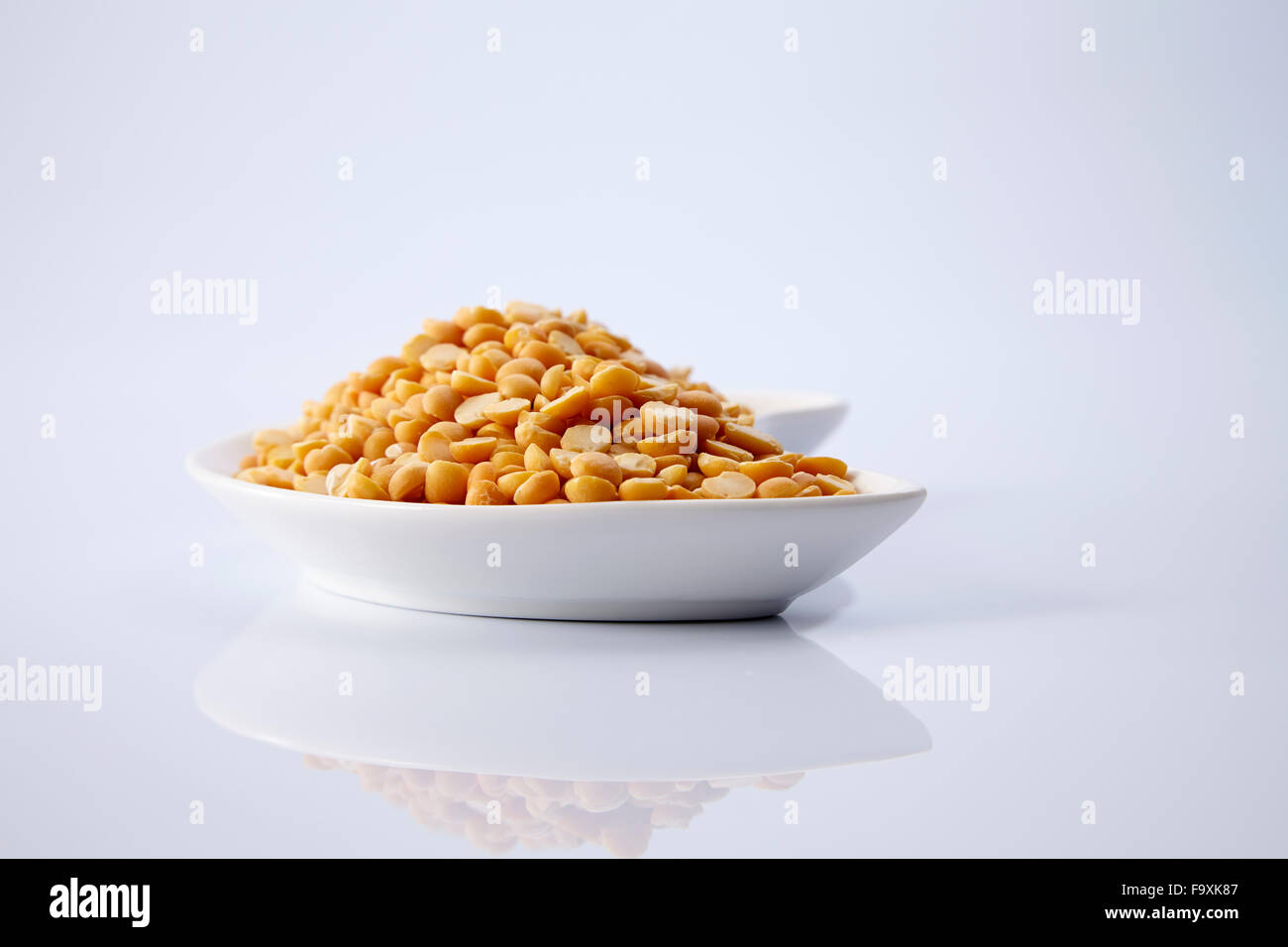 yellow daal on the white background Stock Photo - Alamy