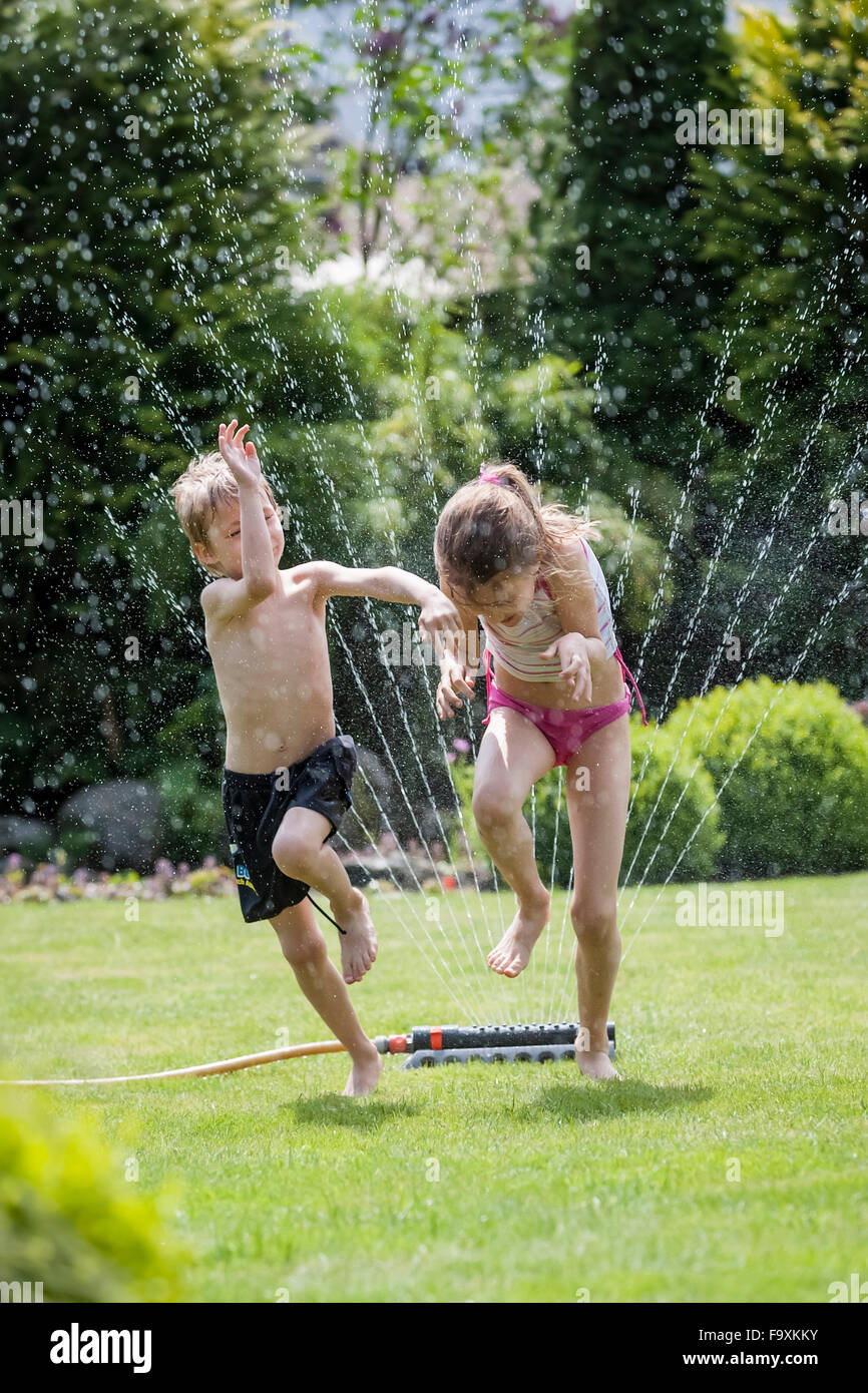 Two children jumping into water hi-res stock photography and images - Alamy