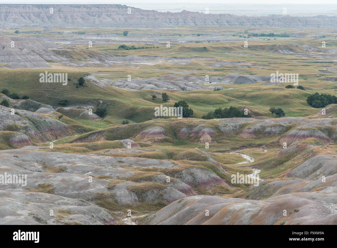 Rolling geologic badlands features give way to shortgrass prairie ...