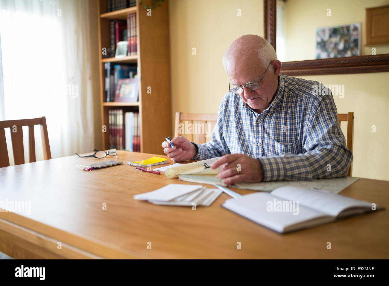 Senior man with road map planning a trip Stock Photo - Alamy