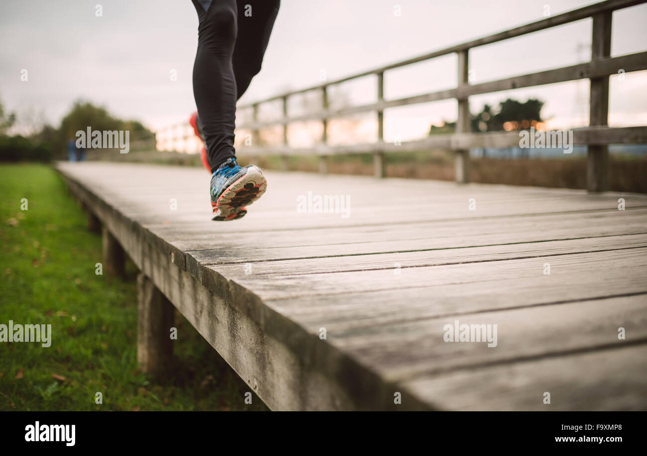 Spain, Naron, legs of a jogger running on a boardwalk Stock Photo - Alamy