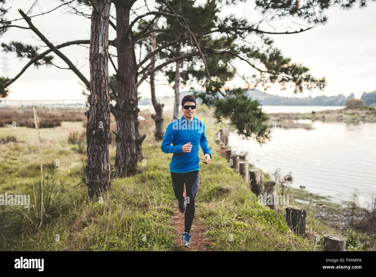 Spain, Naron, jogger running on a path in the shore of the sea Stock ...