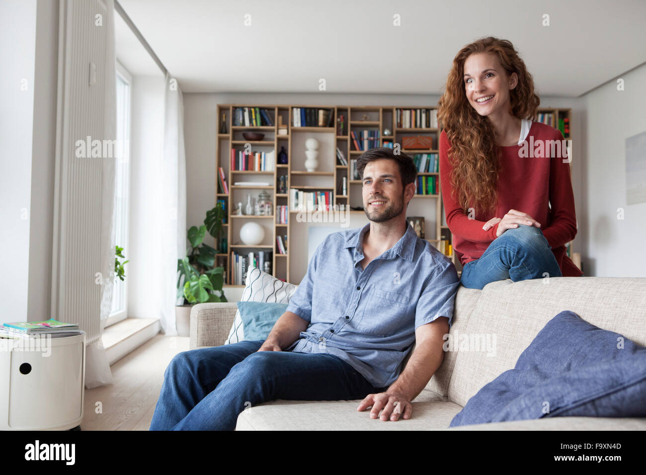 Relaxed couple at home on couch Stock Photo - Alamy