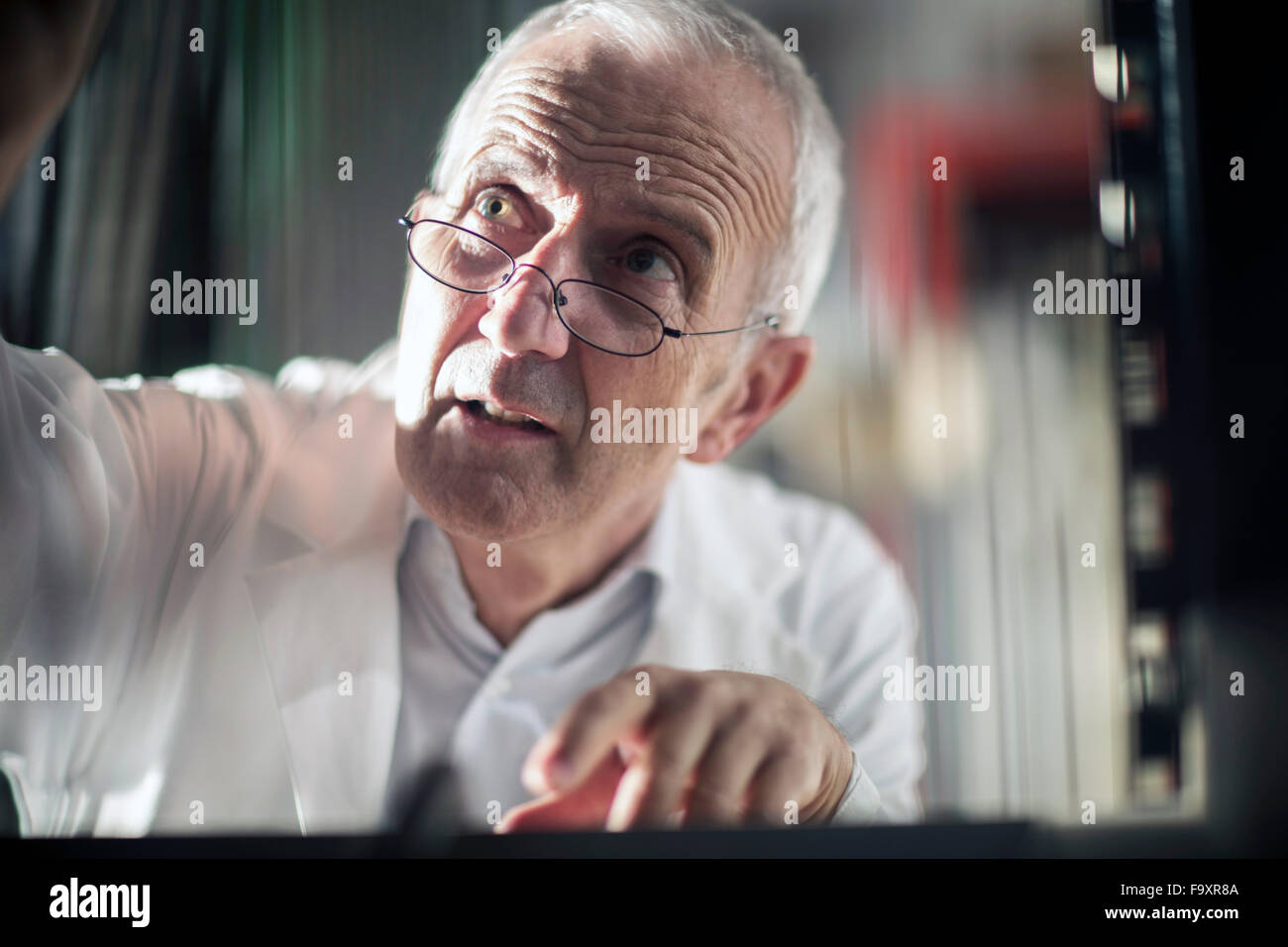 Portrait of man controlling device Stock Photo - Alamy