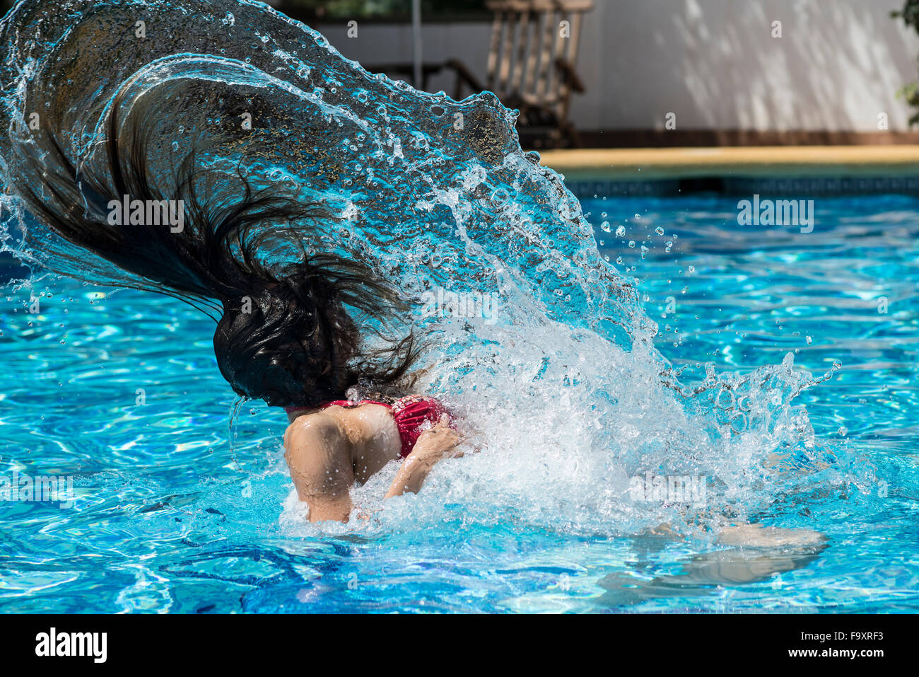 Woman in the pool water with hair pulling Stock Photo - Alamy