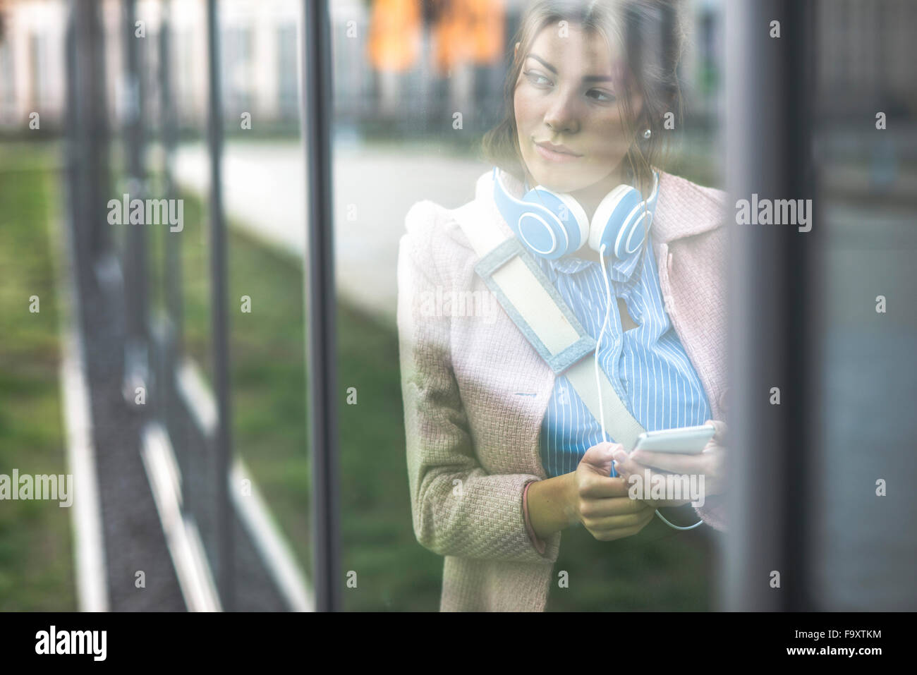 Young woman looking out of window Stock Photo - Alamy