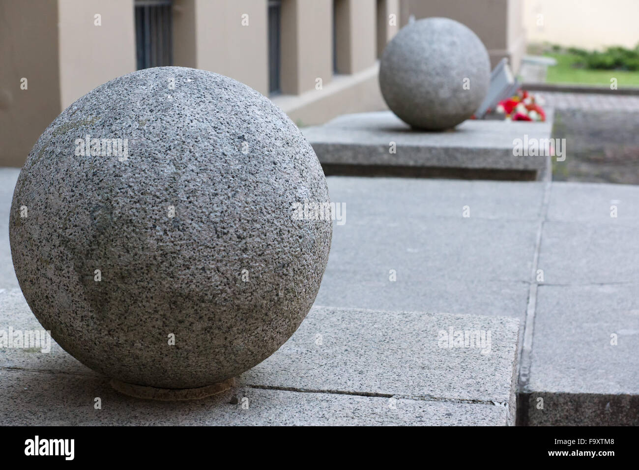 two big granite full-spheres are located at an input to the building ...