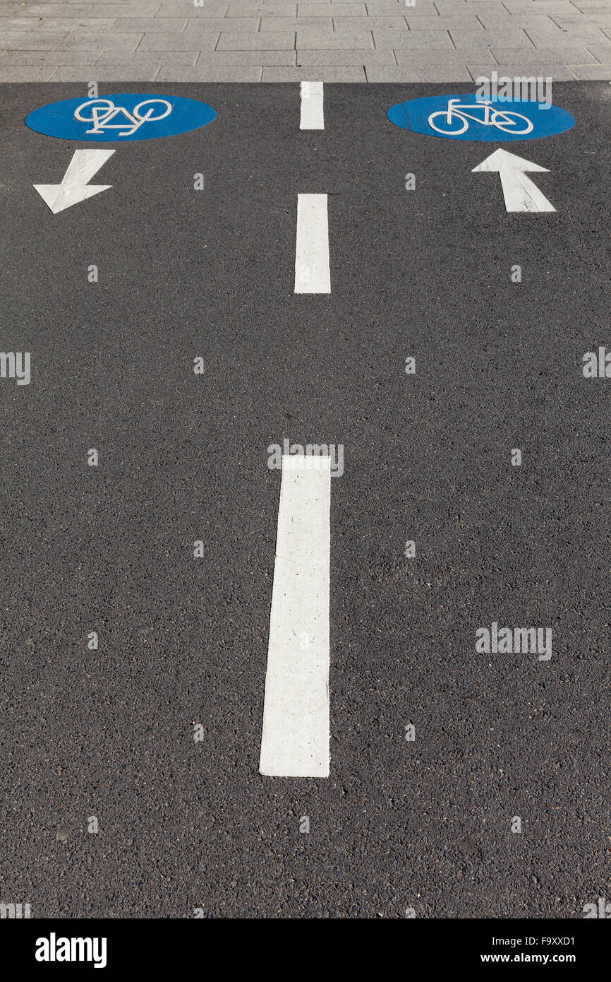 Arrow signs on bicycle lane Stock Photo - Alamy