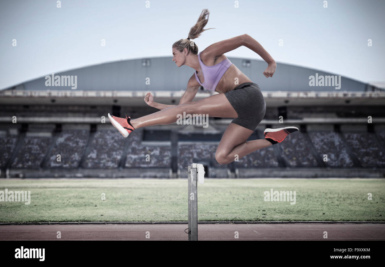 Athlete jumping over hurdle Stock Photo - Alamy