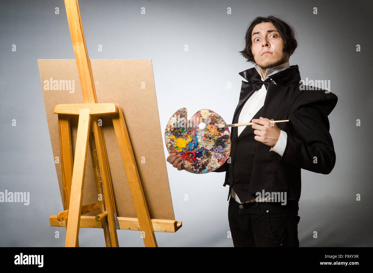 Funny artist in dark studio Stock Photo - Alamy
